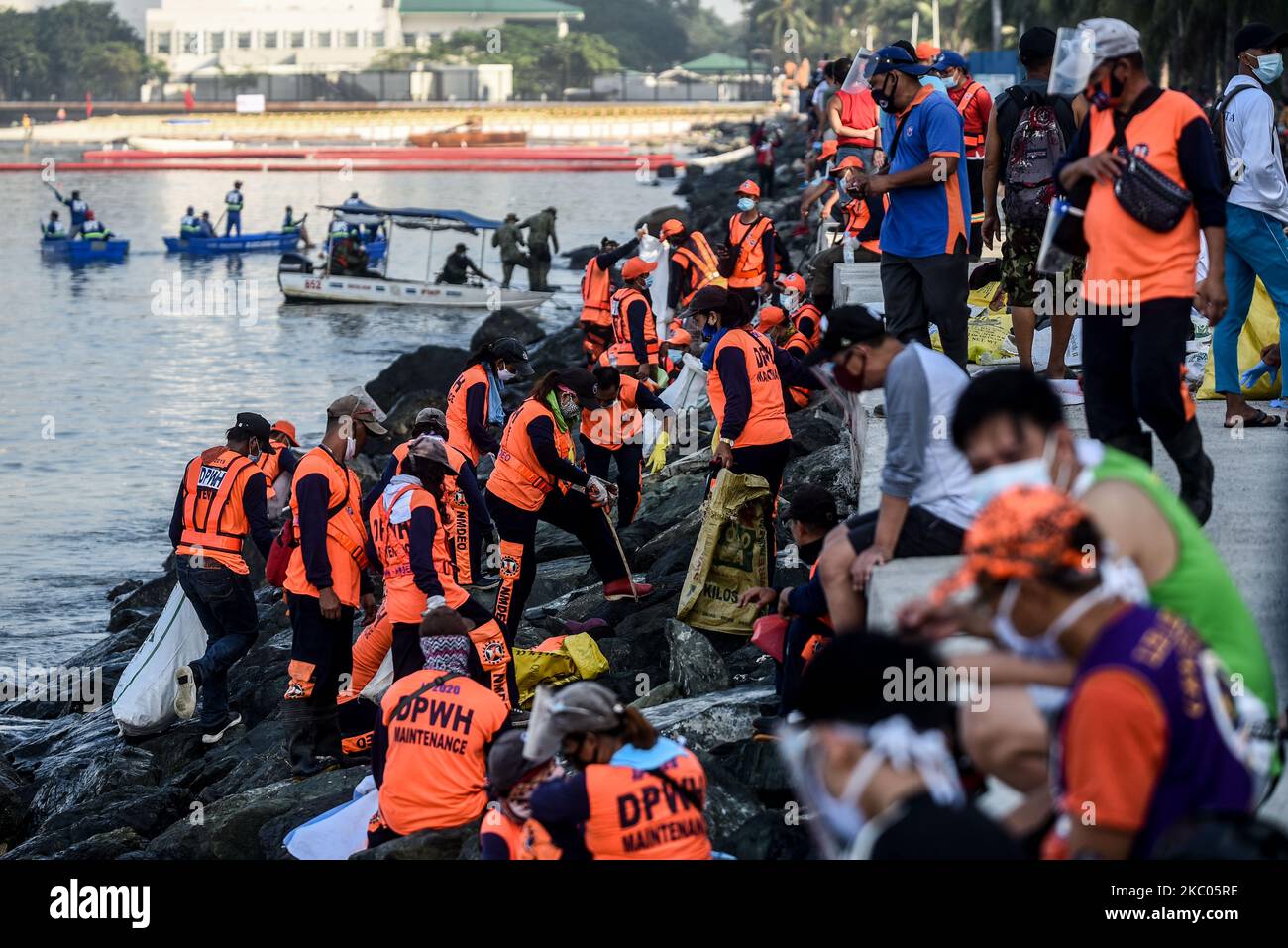Workers and volunteers clean a portion of Manila Bay in celebration of ...