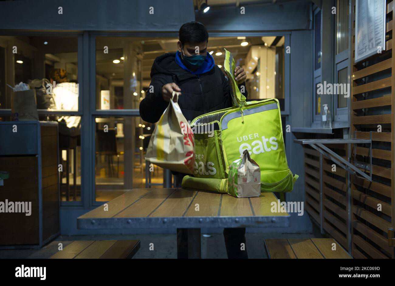 A fast food delivery man packs food to deliver on September 18, 2020 in ...