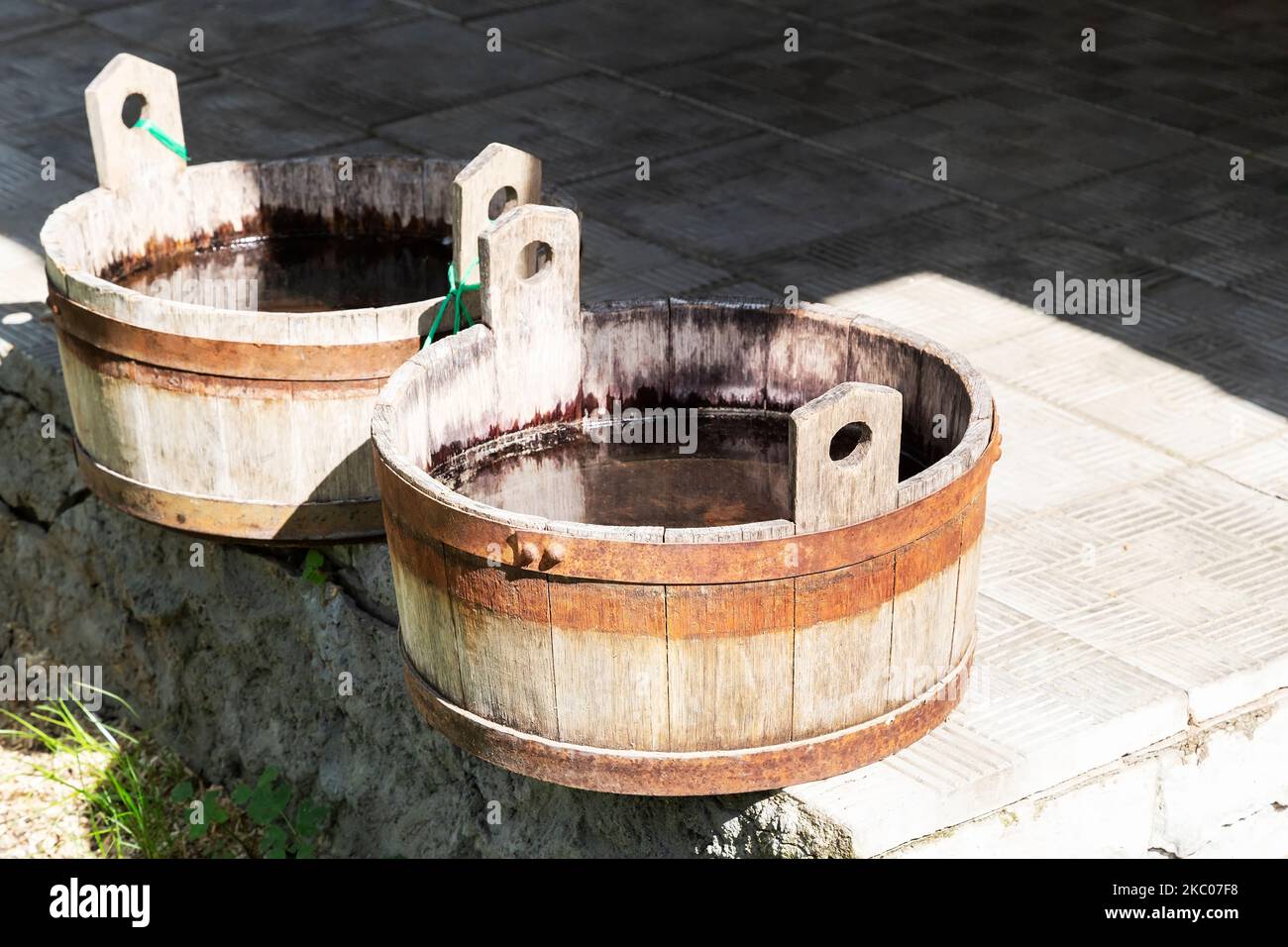 Two antique water vats made of oak planks, fastened together with an ...