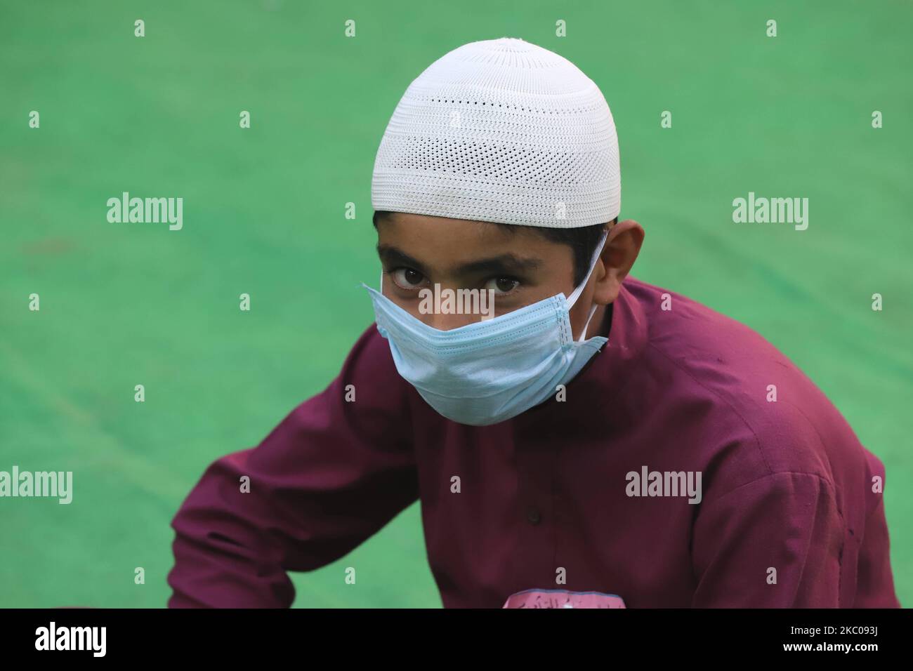 Muslim boy wearing a face mask takes part in Annual Conference amid ...