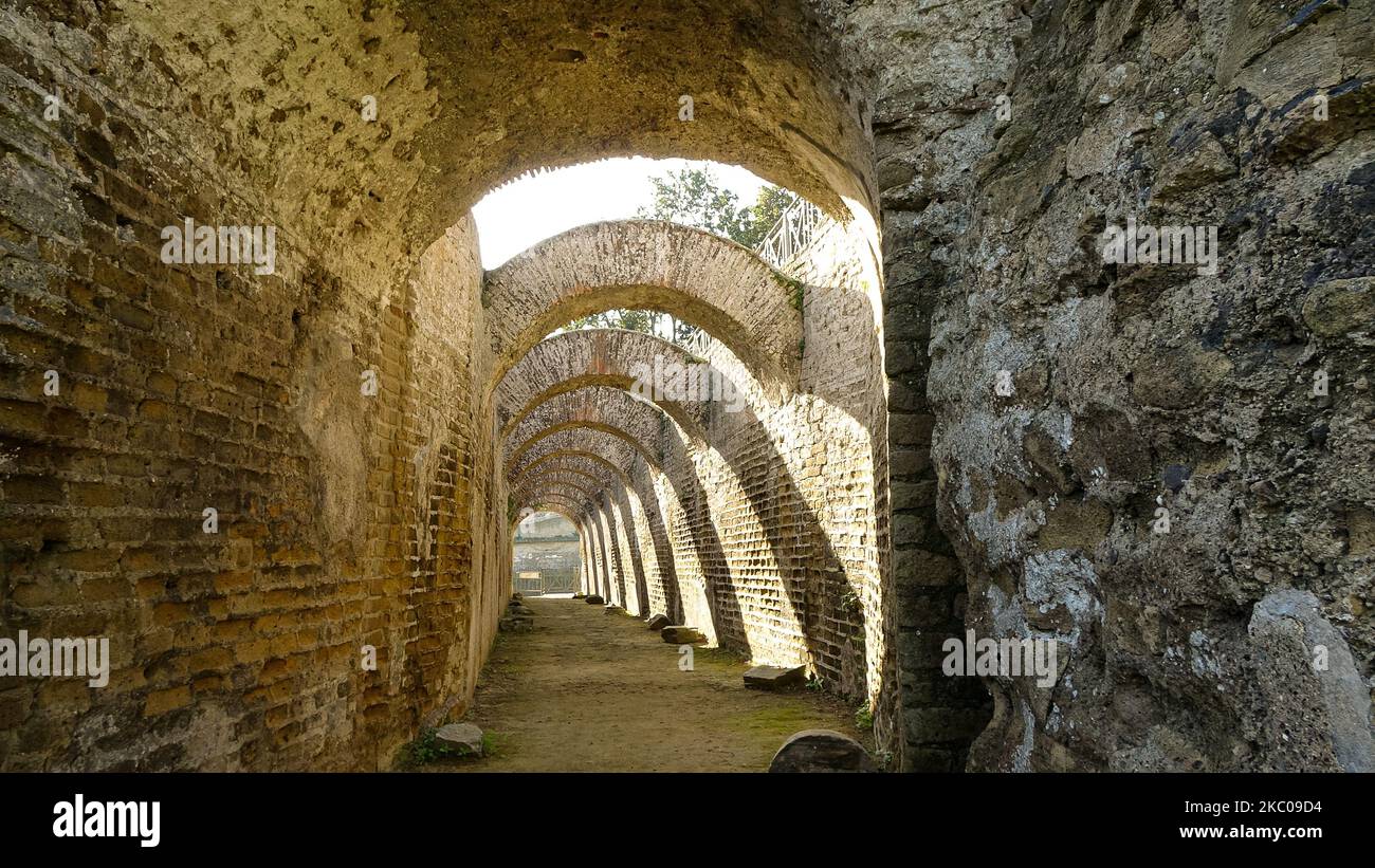 A passage under the arches of the ancient Roman baths of Baia, near ...