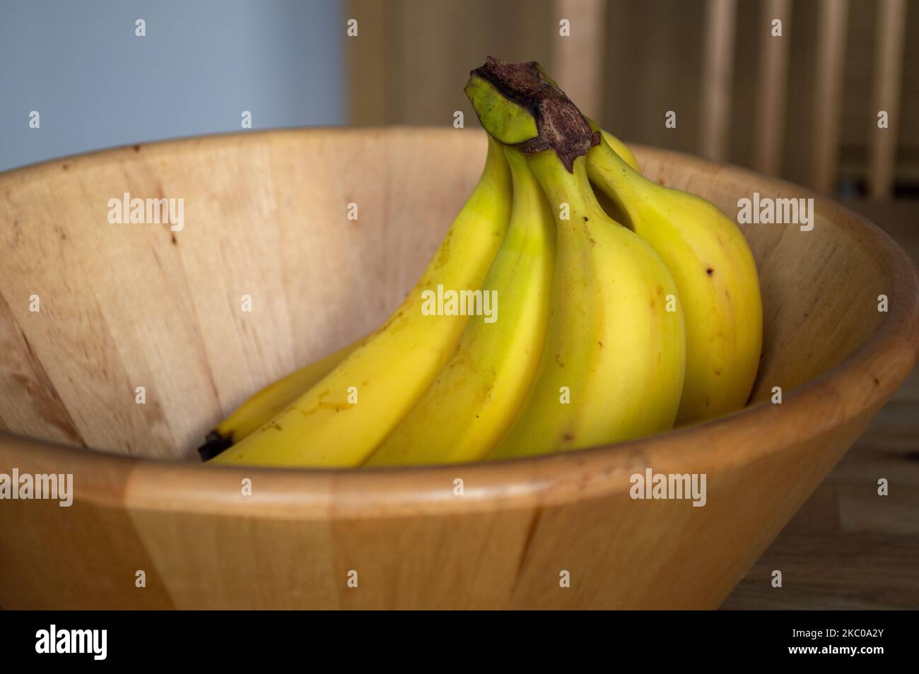 Bunch of Bananas in a Bamboo Wood Fruit Bowl Stock Photo - Alamy