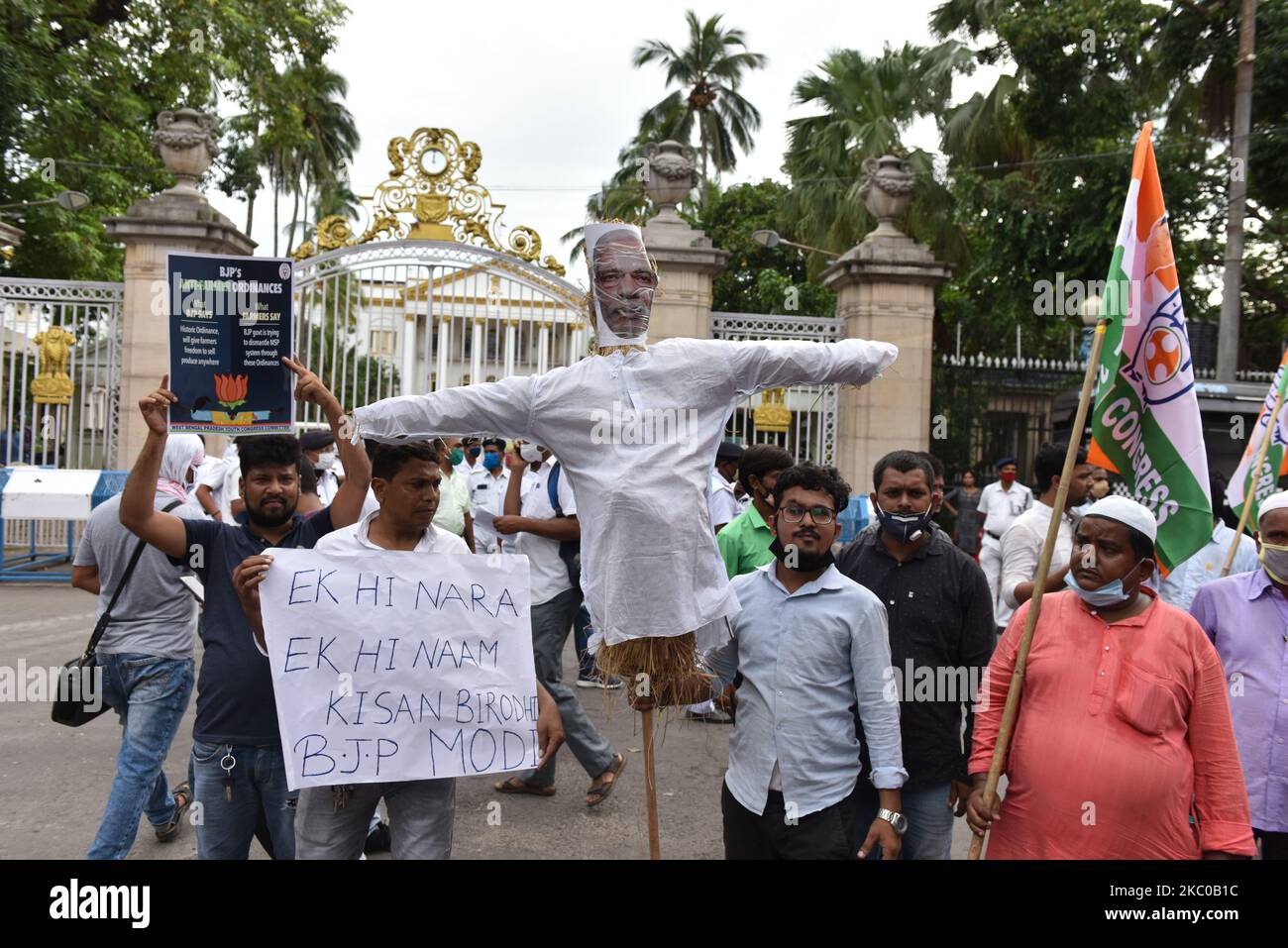 Congress members stands infront of Raj Bhavan holding posters along ...