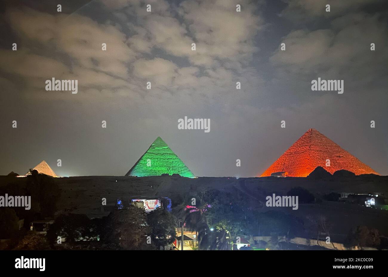View of the Sphnix lit up in front of the Great Pyramids during the ...