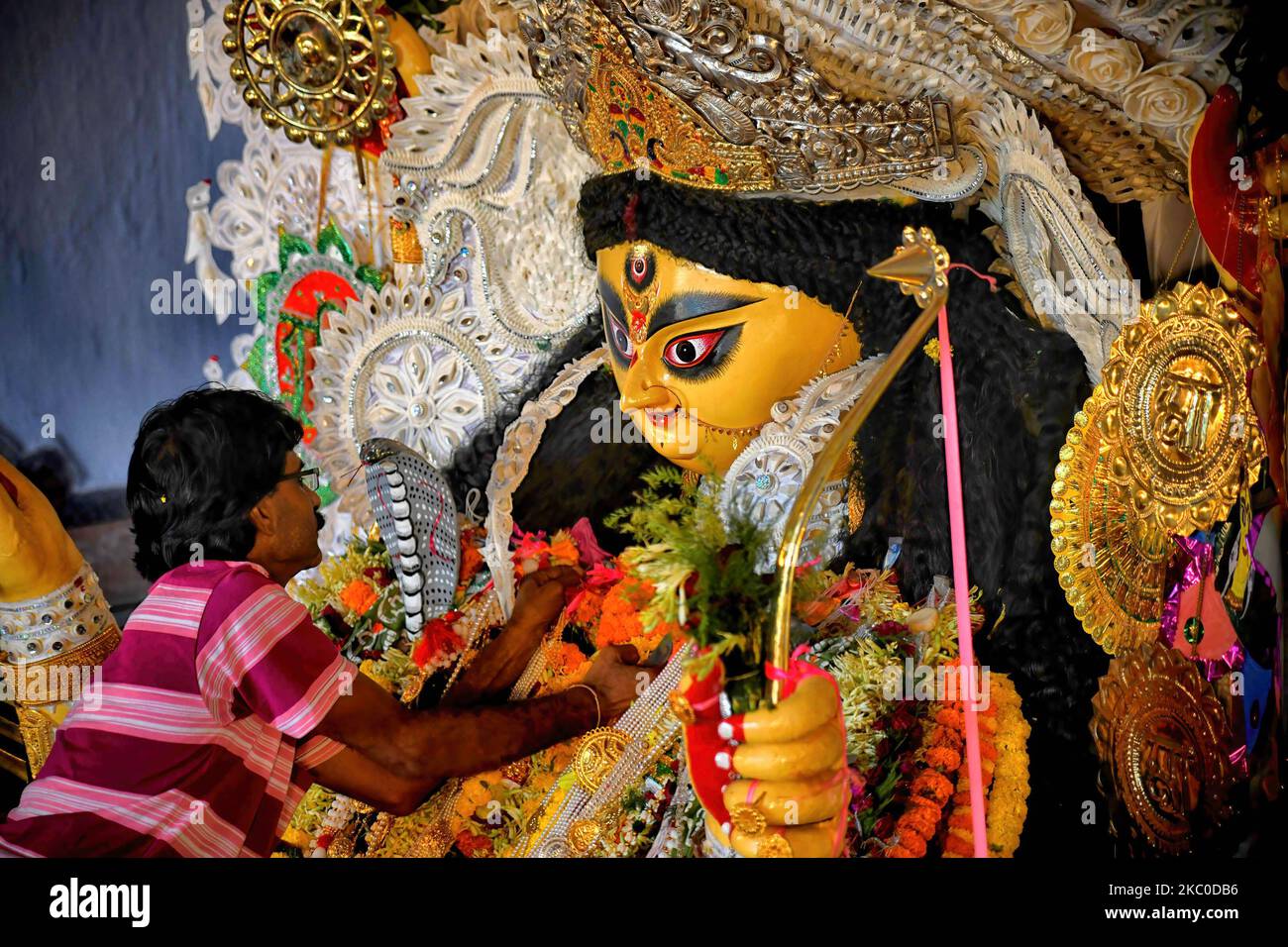 A Hindu devotee performs the final worship before the immersion of ...
