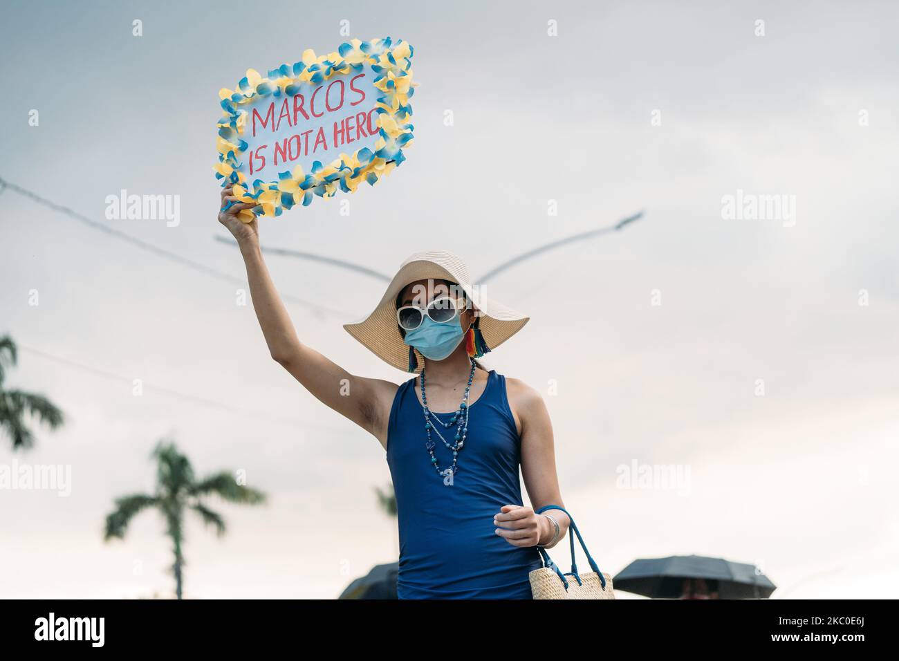 A protester holds a placard that says 'Marcos No Hero' during the ...