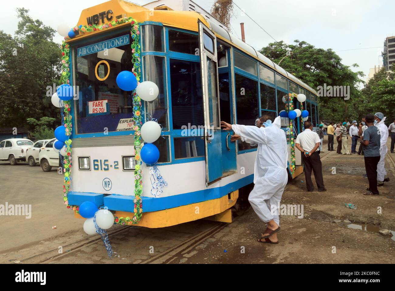 Tram conductors wearing conductor wearing a protective suit gets of the ...