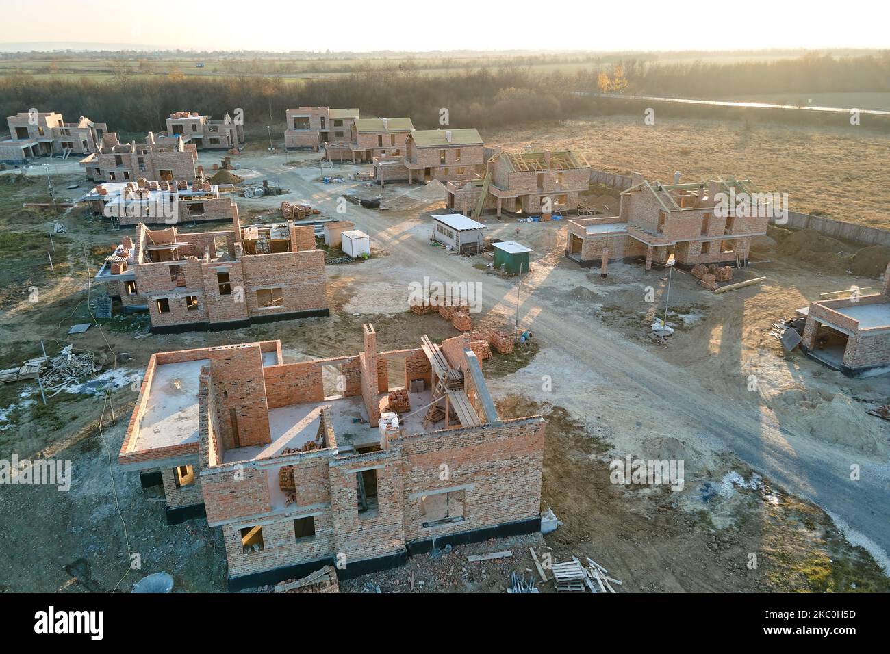 Aerial view of new homes with brick framework walls under construction ...