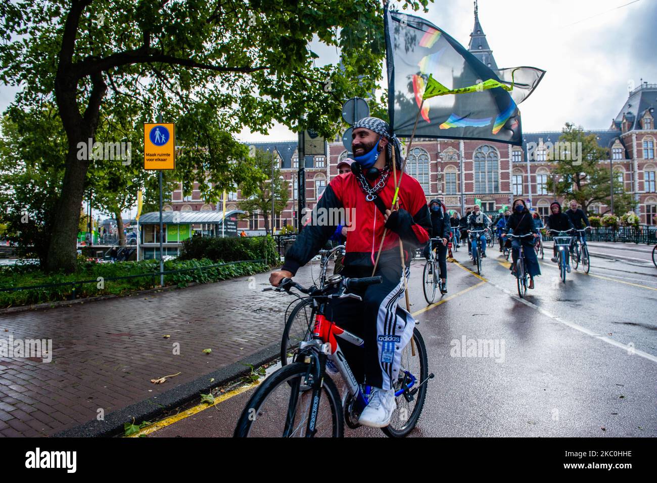 Climate activists and students are seen crossing the Rijksmuseum with ...