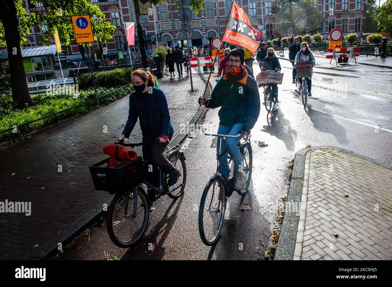 Climate activists and students are seen crossing the Rijksmuseum with ...