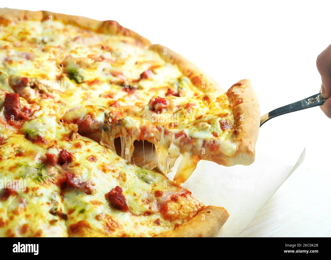 Getting slice of pizza with melting cheese on a white background Stock ...