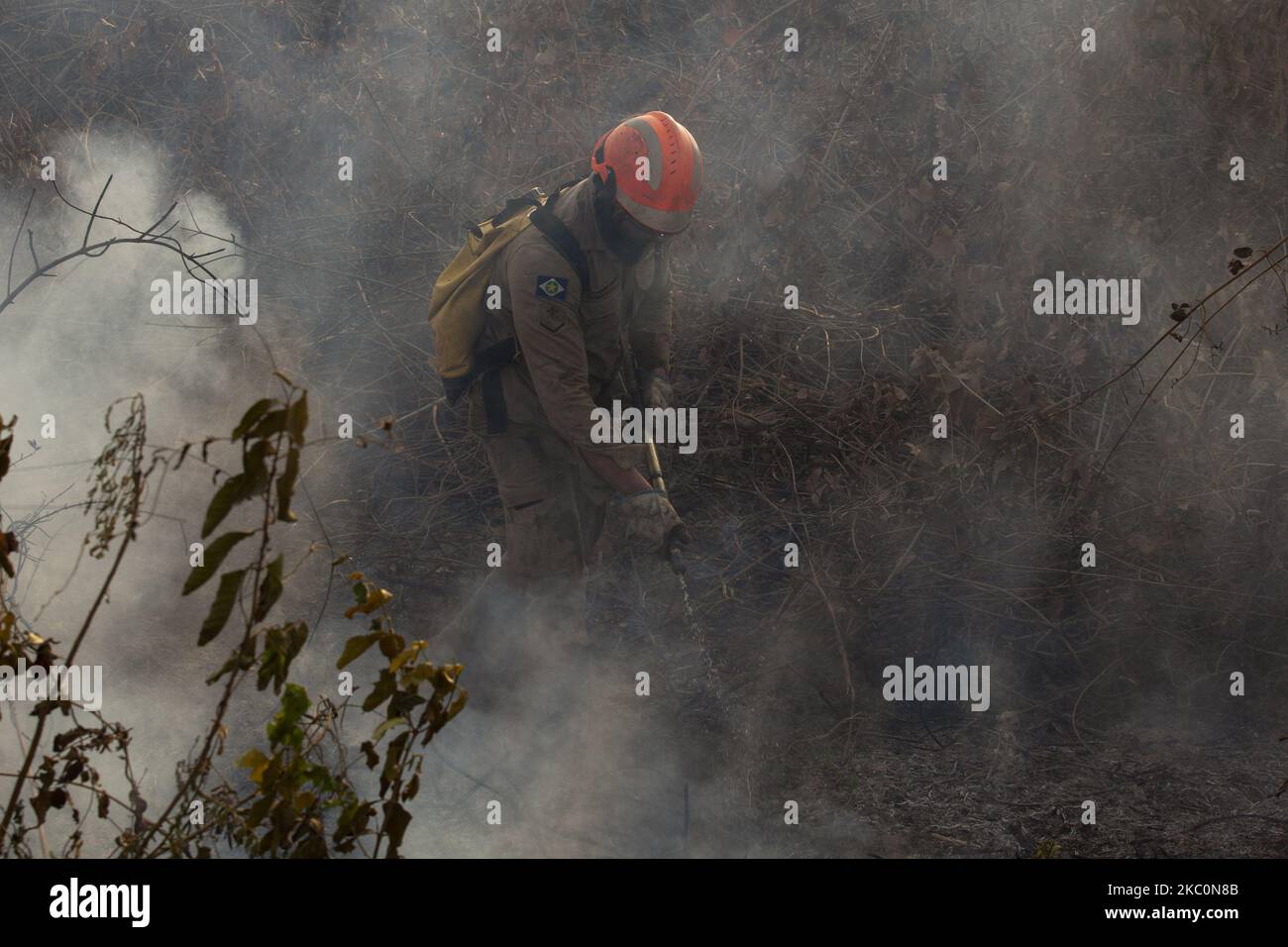 Firefighters fight underground fire on September 26, 2020, on the banks ...