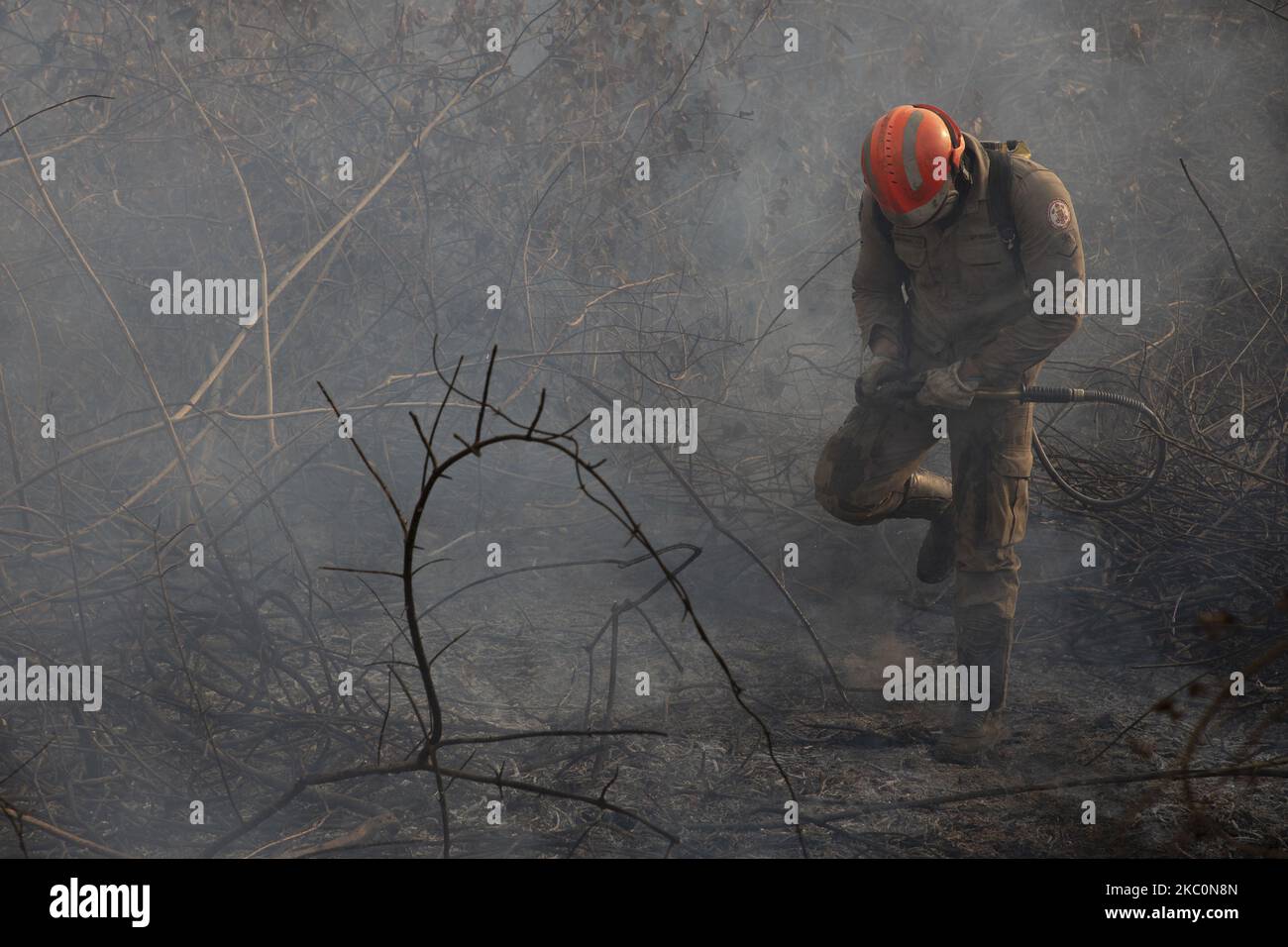 Firefighters fight underground fire on September 26, 2020, on the banks ...