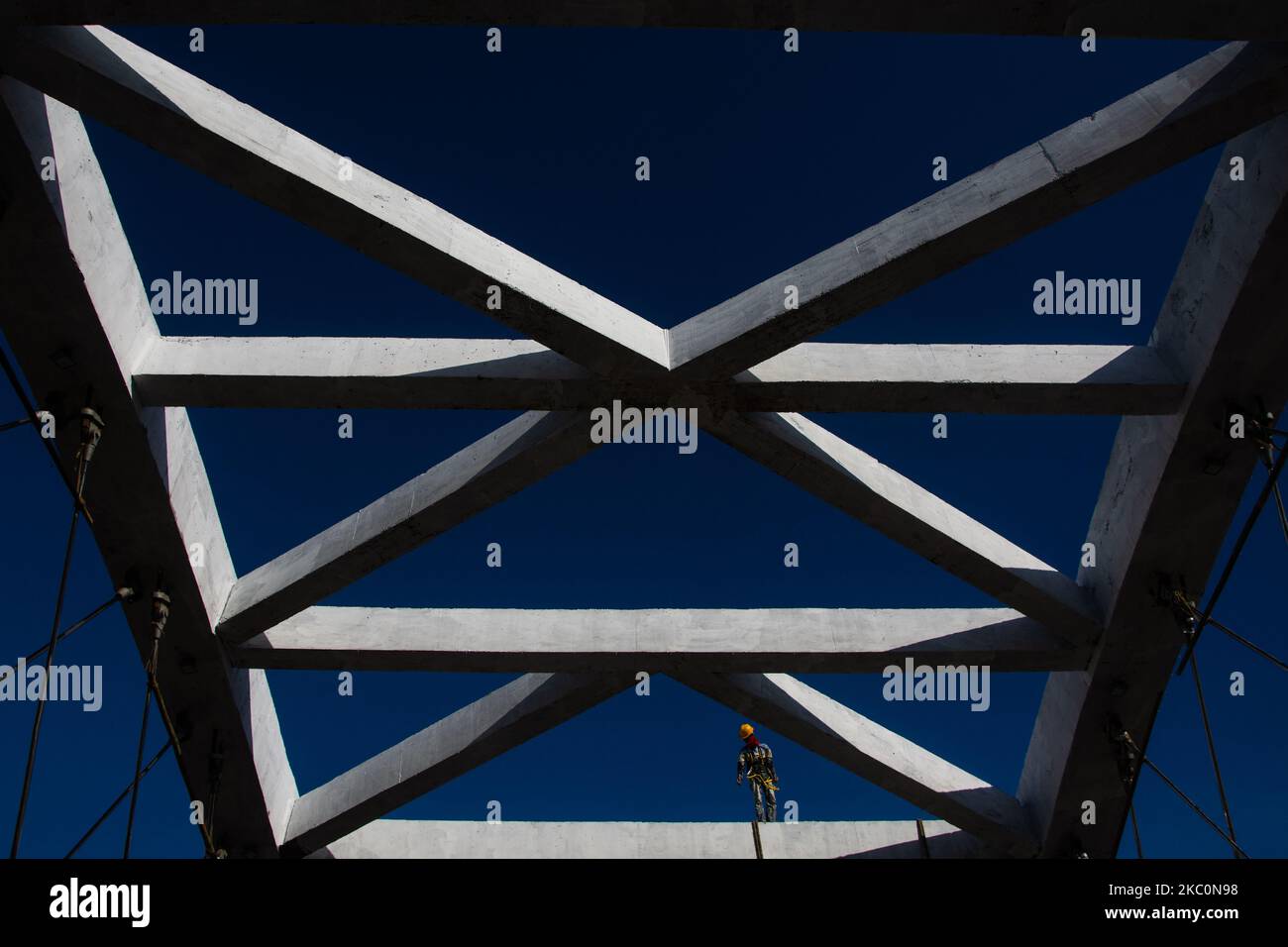Nepalese construction workers work on a newly built bridge at Kathmandu ...