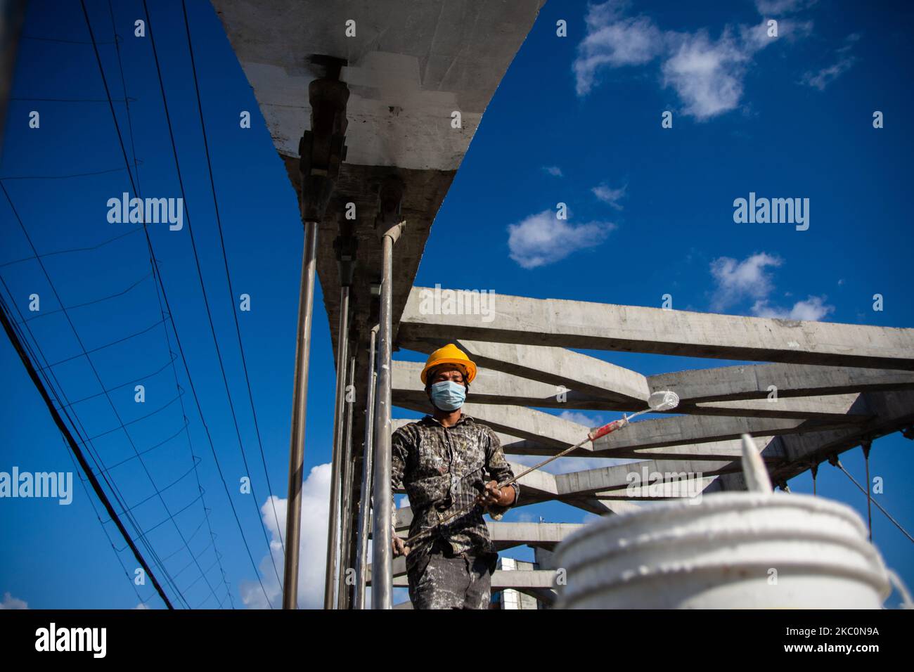Nepalese construction worker paint a newly built bridge at Kathmandu ...