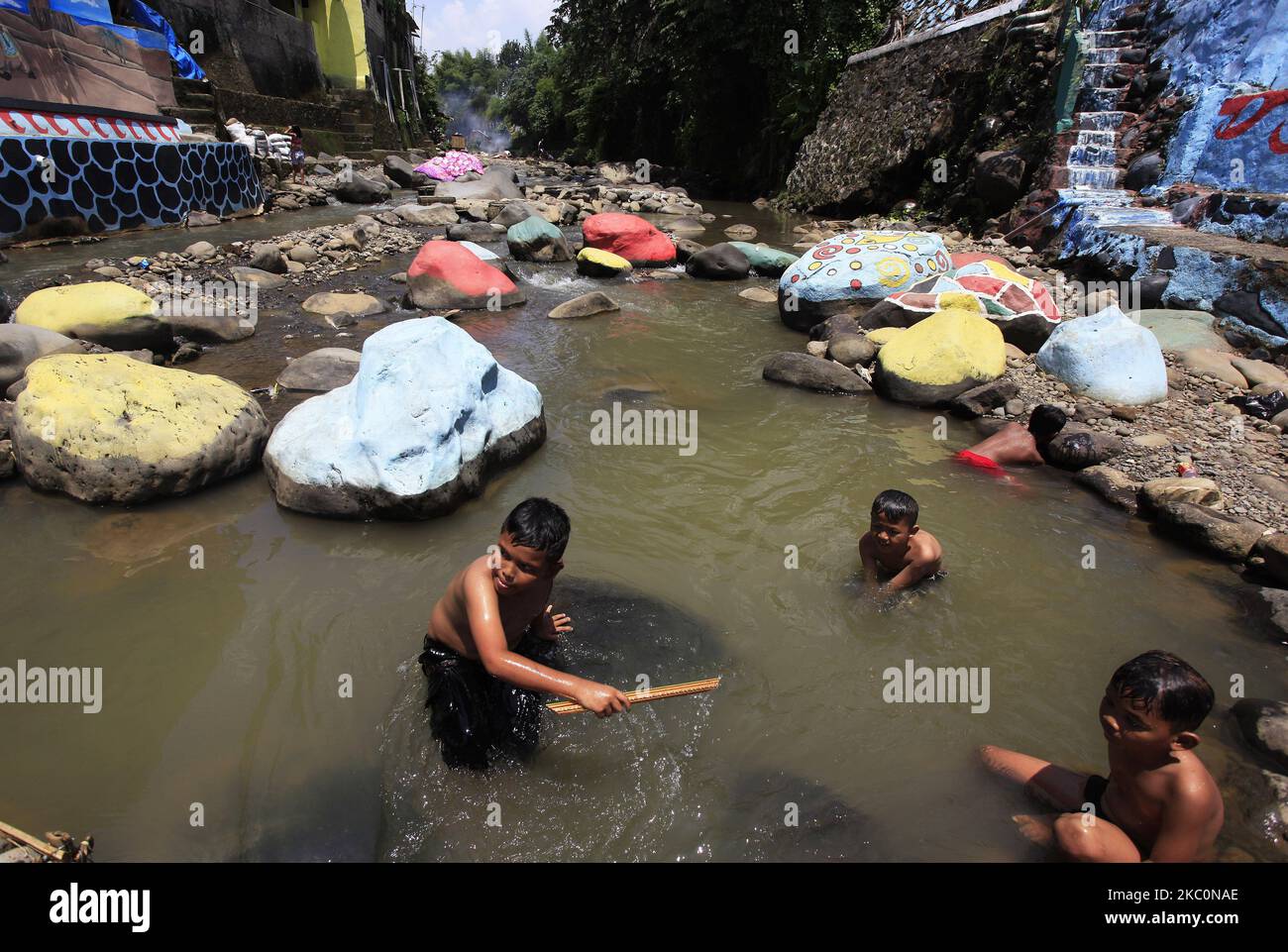 Indonesian children playing at the Ciliwung river in Bogor, West Java ...