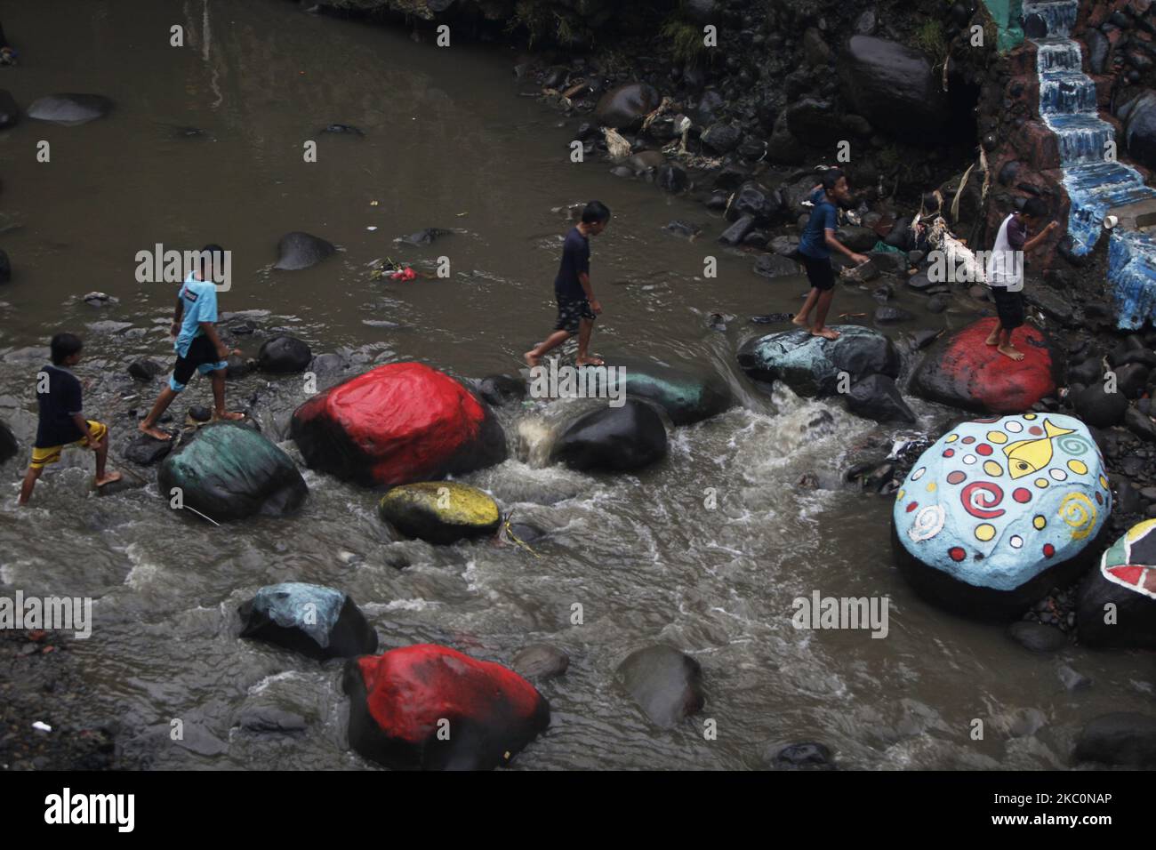 Indonesian children playing at the Ciliwung river in Bogor, West Java ...