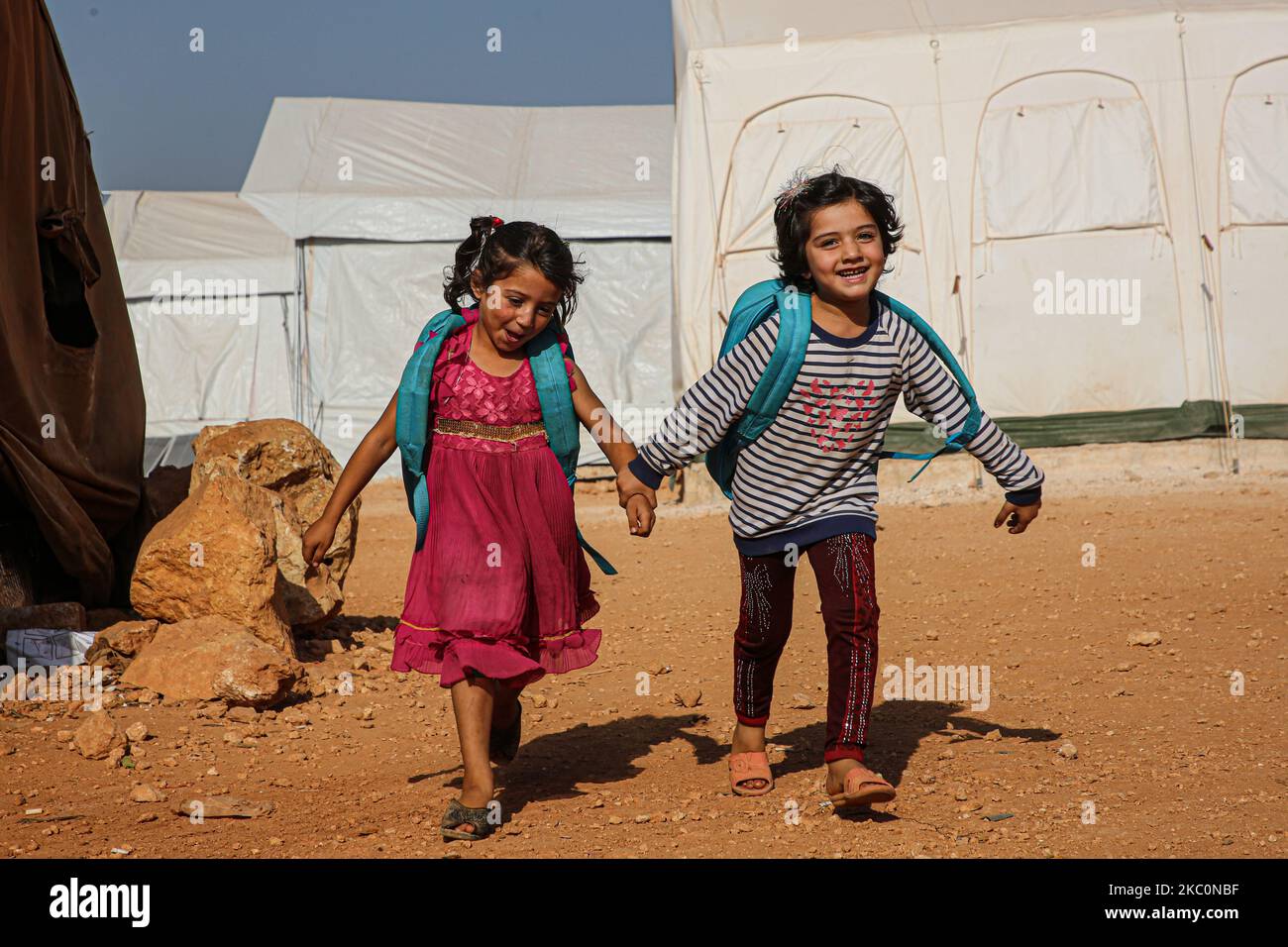 Syrian students play in front of their school tent on the first day of ...
