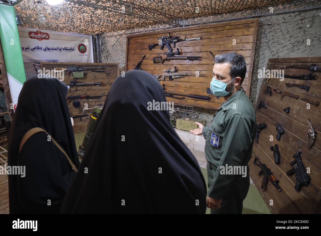 A member of the Islamic Revolutionary Guard Corps (IRGC) speaks with ...