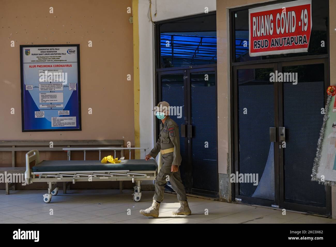 An officer walks in front of the COVID-19 treatment room at the ...