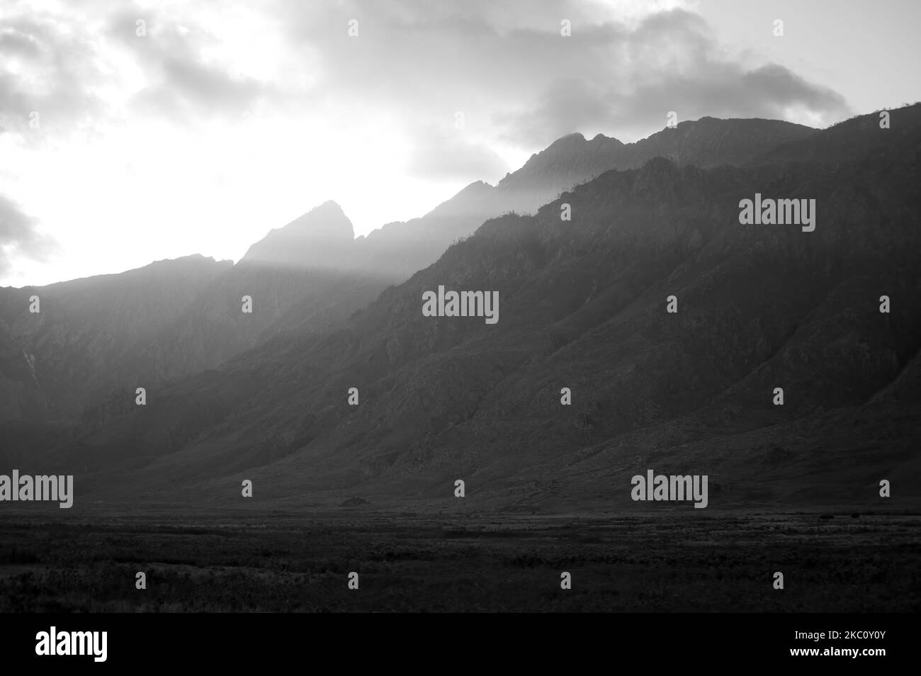 The foggy sunset view over the dark mountains, grayscale Stock Photo ...