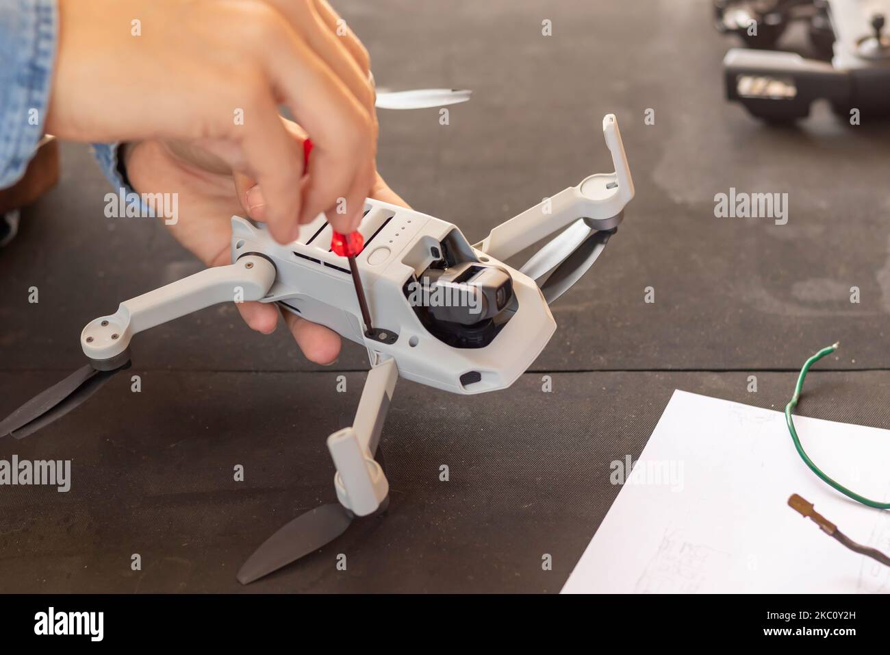 Close up view of unrecognizable man hands repairing small drone with ...