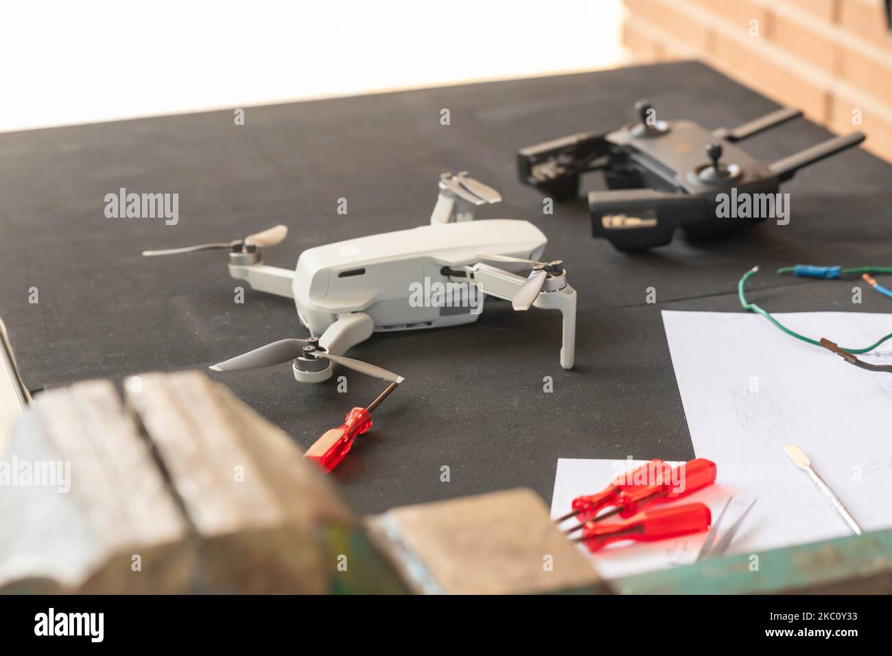 Selective focus of small drone on tool bank with remote controller and ...