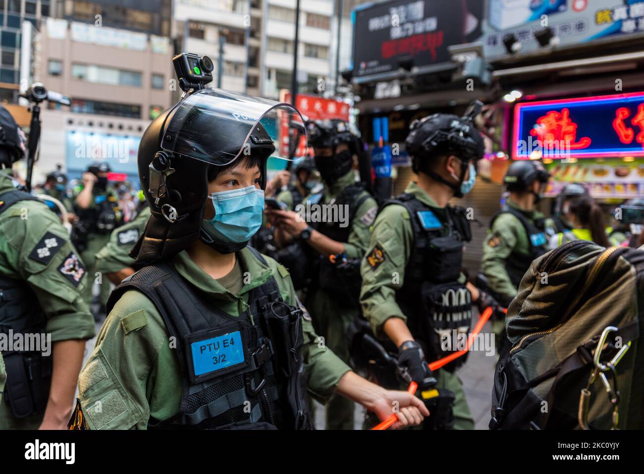 A riot policewoman mans a cordon holding journalists in Causeway Bay in ...