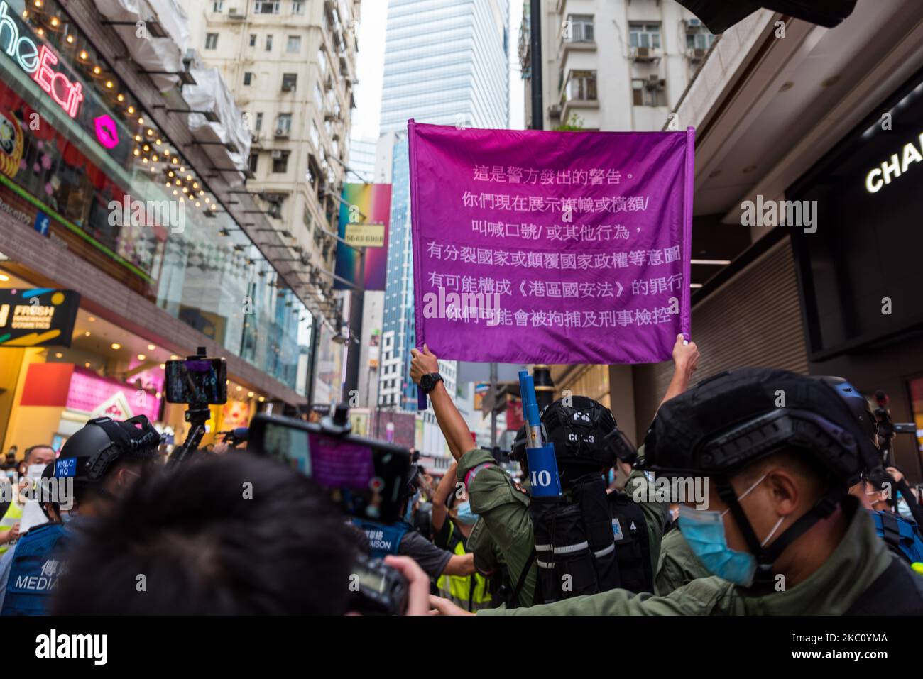 Riot police deploy the purple flag warning of acts contrary to the ...