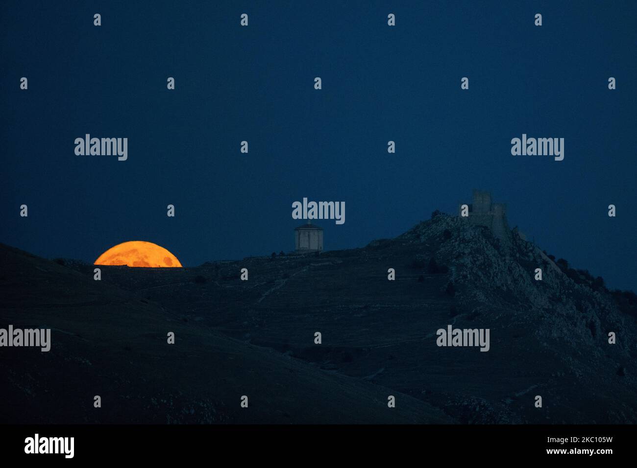 Harvest moon shining behind Rocca Calascio Castle, Abruzzo, Italy on ...