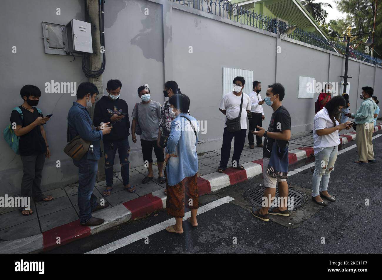 Myanmar citizens in Thailand line up as they take part in the pre ...