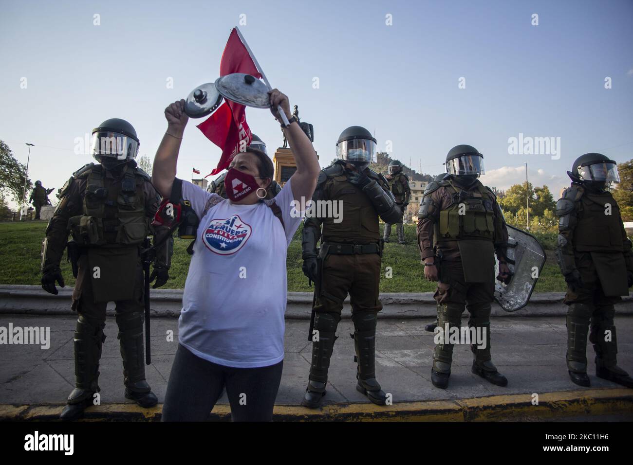A woman holds a pot and its lid, to protest against Sebastian PiÃ±era's ...