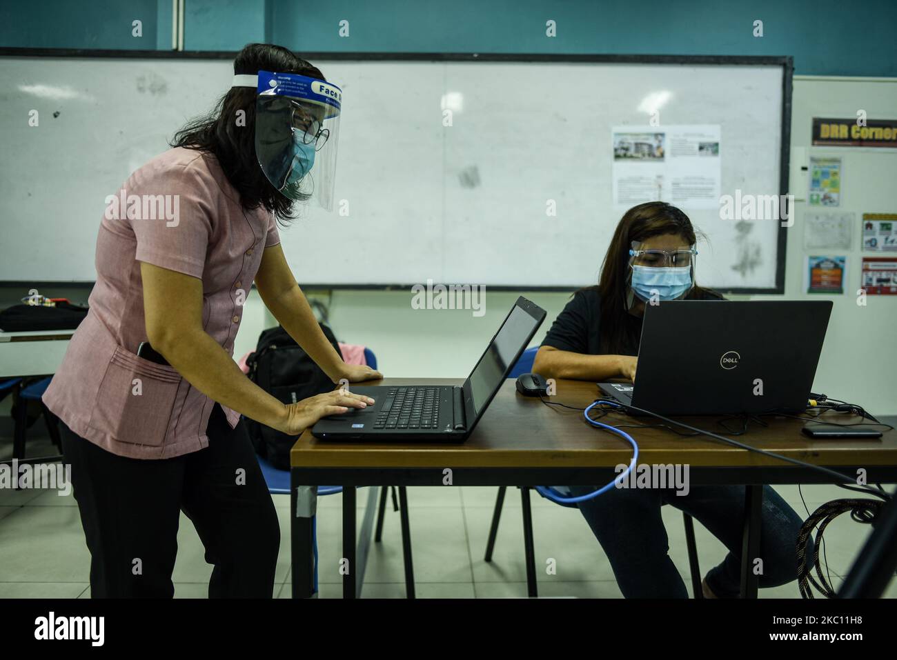 Teachers prepare online lectures for the opening of classes at a school ...