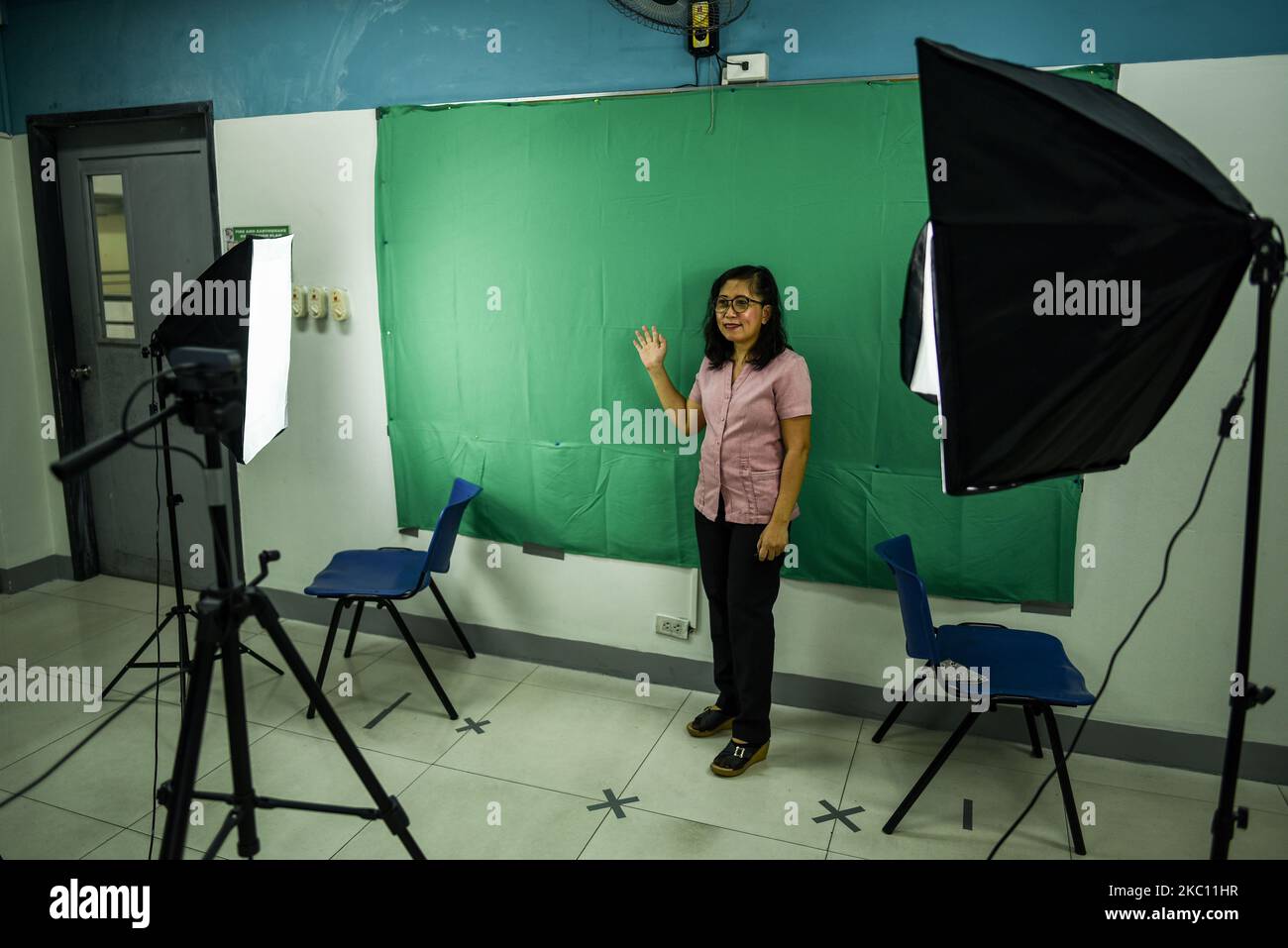 A teacher makes use of green screen in filming lectures in preparation ...