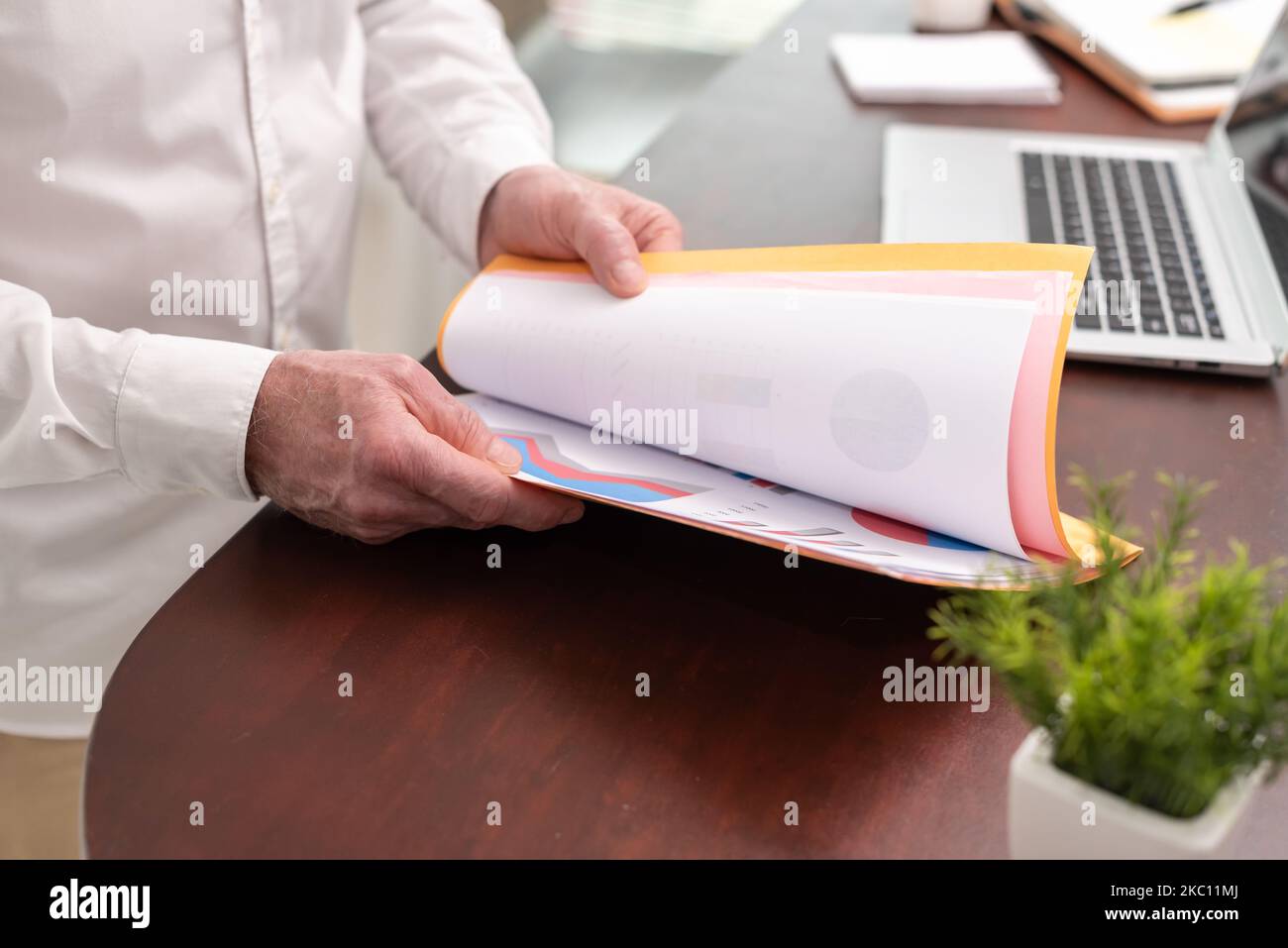 Businessman opening folder with paper documents Stock Photo - Alamy