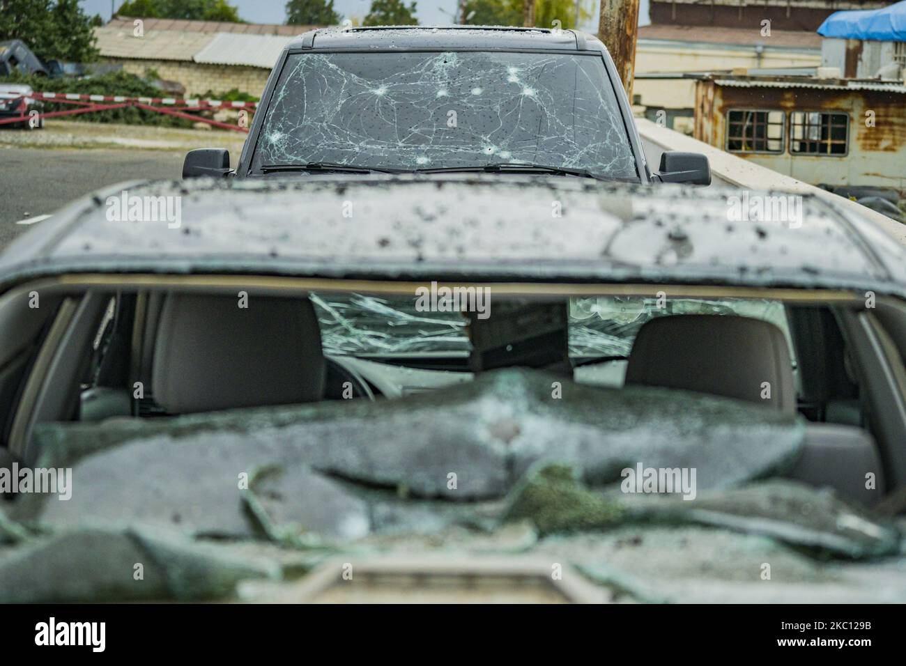 Destroyed cars with shrapnel after the impact of an azeri rocket during ...