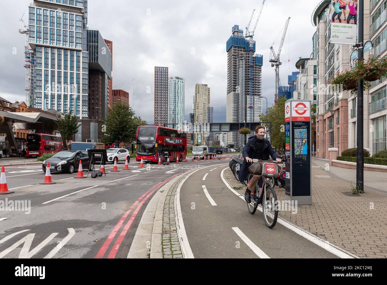 A man in protective face mask is seen riddding on a bycicle path at ...