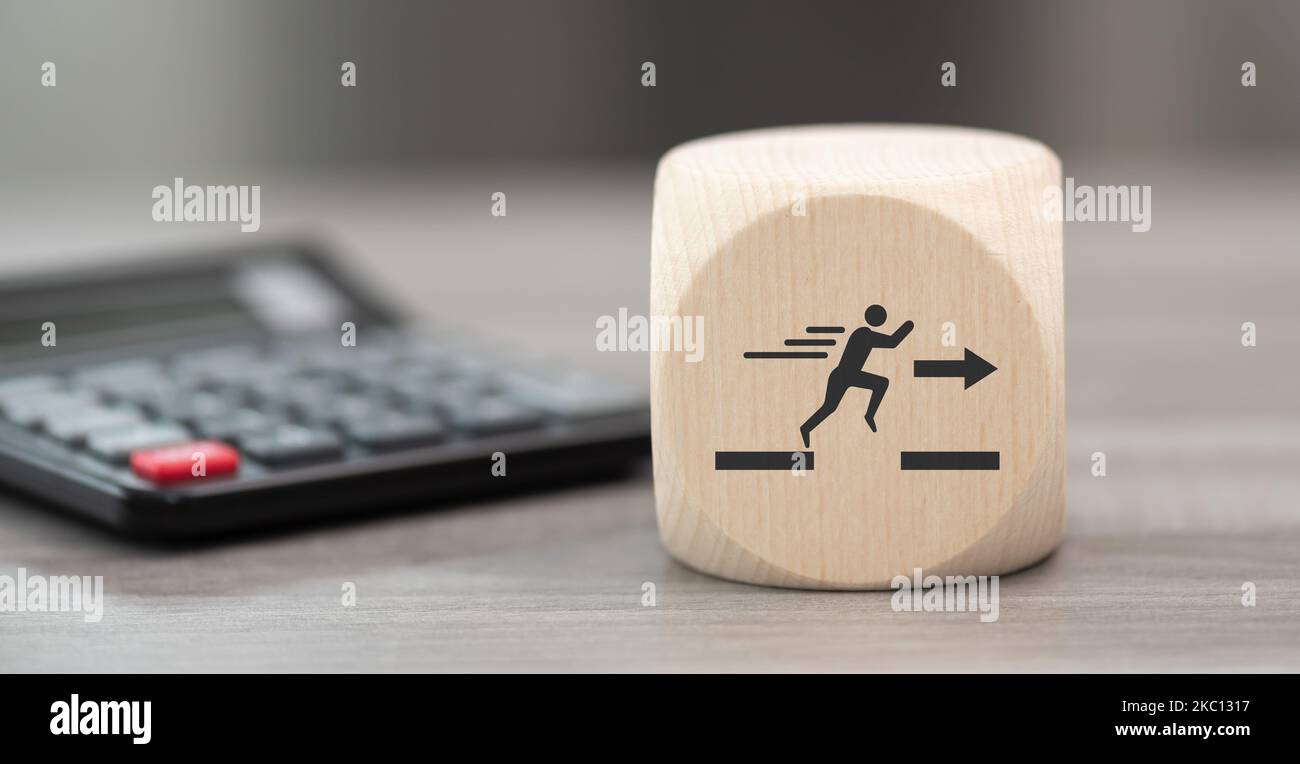 Wooden block with symbol of motivation concept and calculator on ...