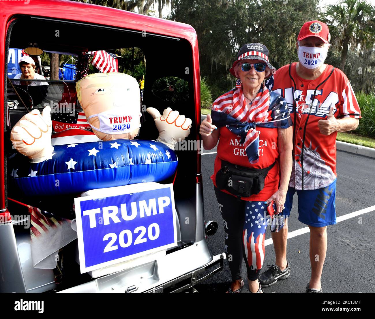 Bill and Marti Biggs pose with their decorated golf cart while waiting ...