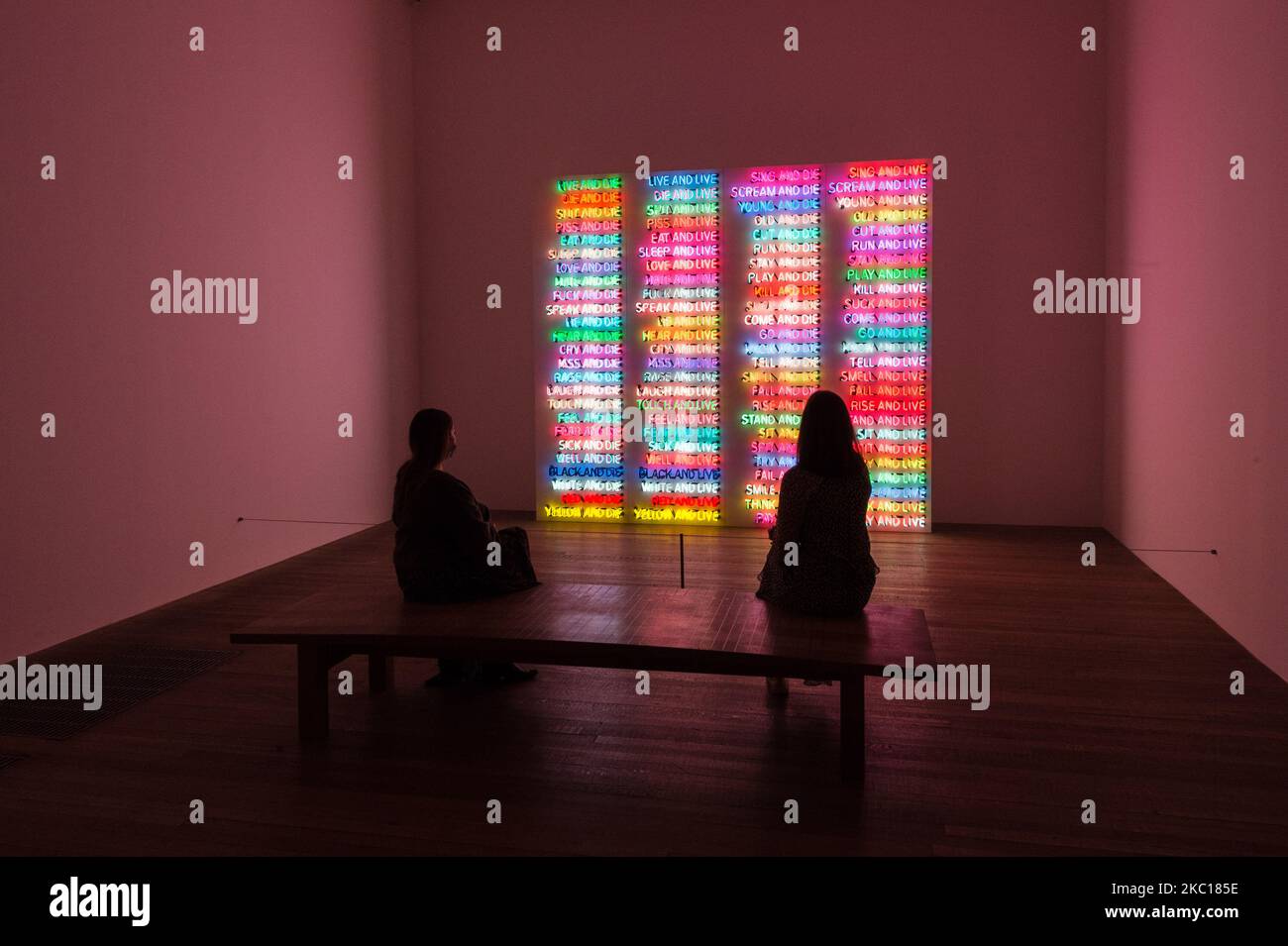 Gallery staff members look at "One Hundred Live and Die" 1984 by an ...