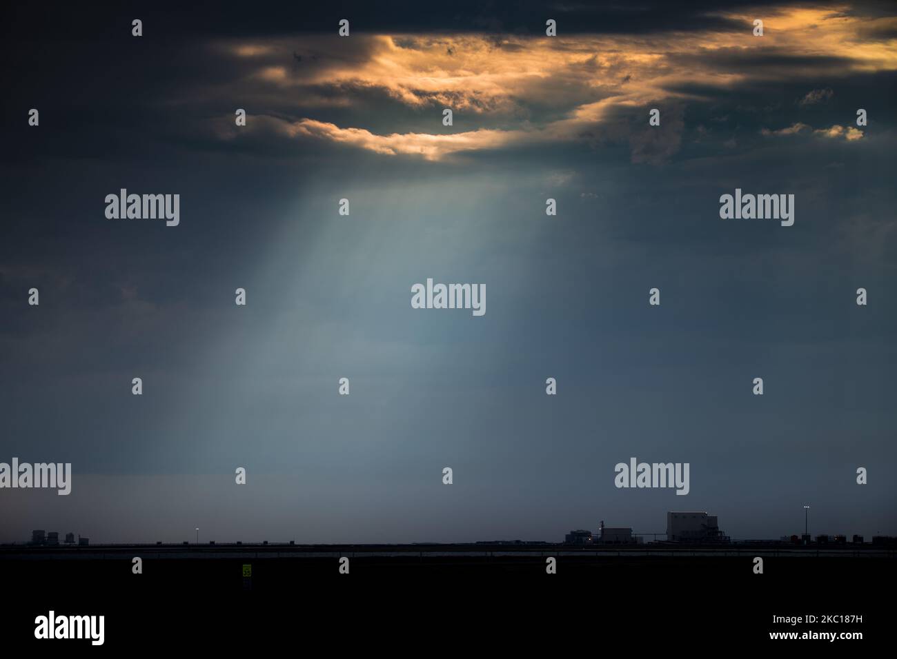 A beautiful dark sunset on a landscape with city buildings in the ...