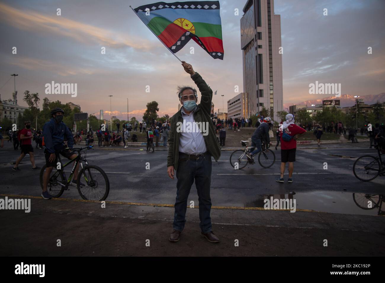 An older adult flies the flag of the Mapuche nation-people. In the ...