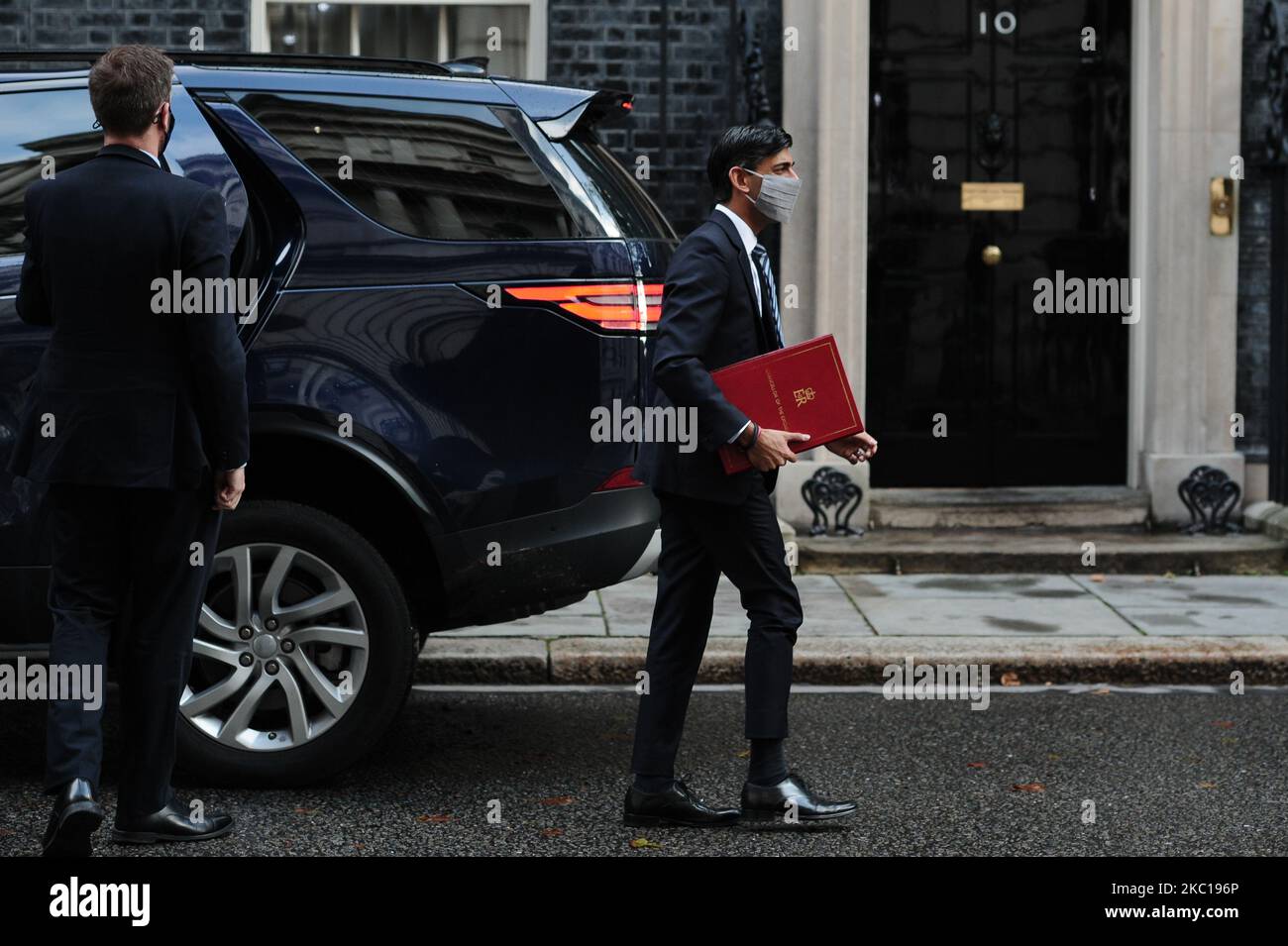 Chancellor of the Exchequer Rishi Sunak, wearing a face mask, arrives ...