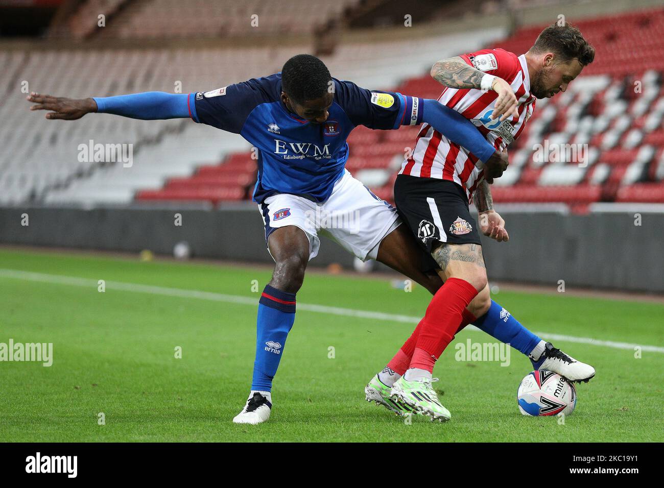 Aaron Hayden of Carlisle United challenges Chris Maguire of Sunderland ...