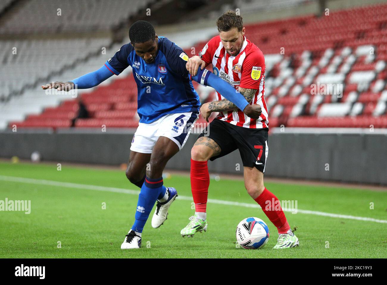 Aaron hayden of carlisle united challenges chris maguire of sunderland ...