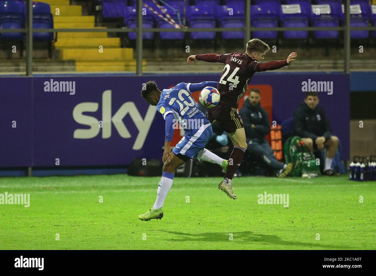 Dior Angus of Barrow contests a header with Leif Davis of Leeds United ...