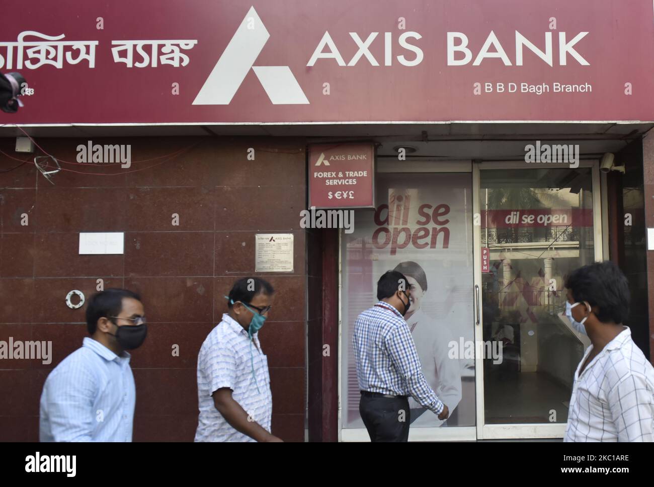 People walk past an Axis Bank in Kolkata, India, 07 October, 2020. Axis ...