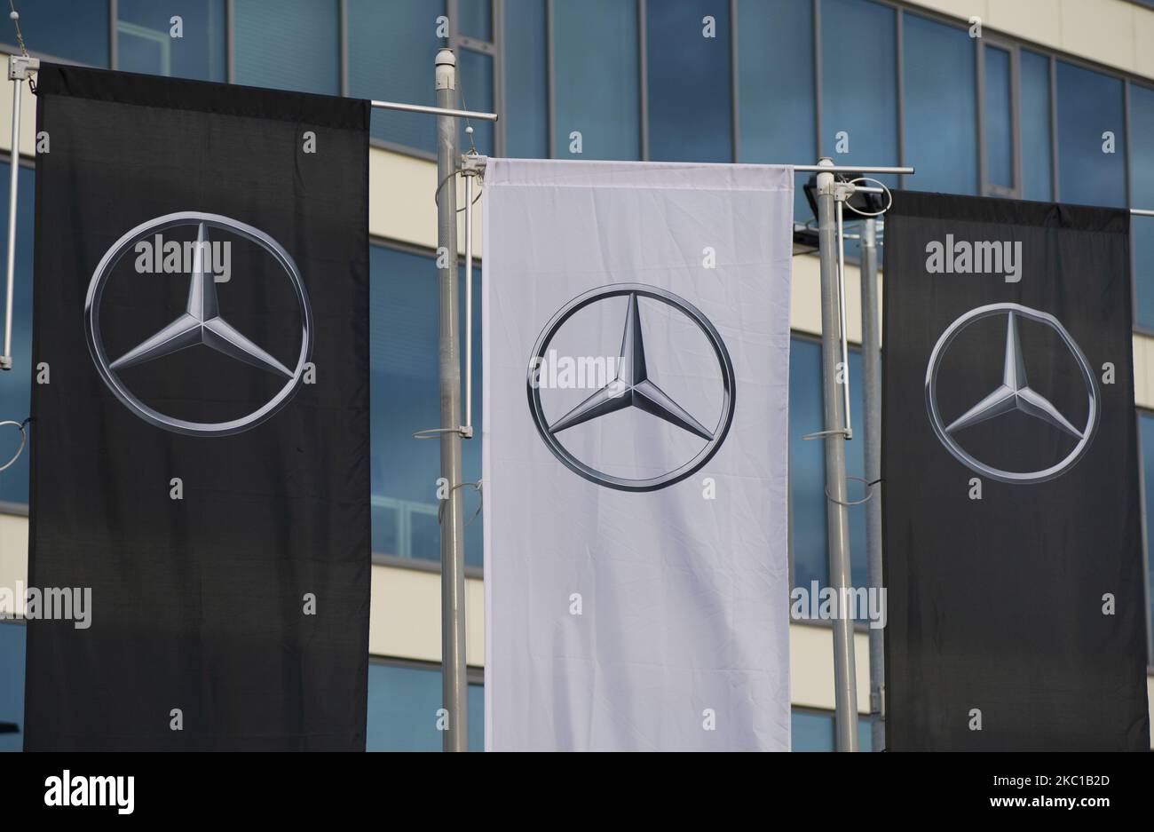 Flags with Mercedes-Benz logo are seen on October 7, 2020 in Warsaw ...
