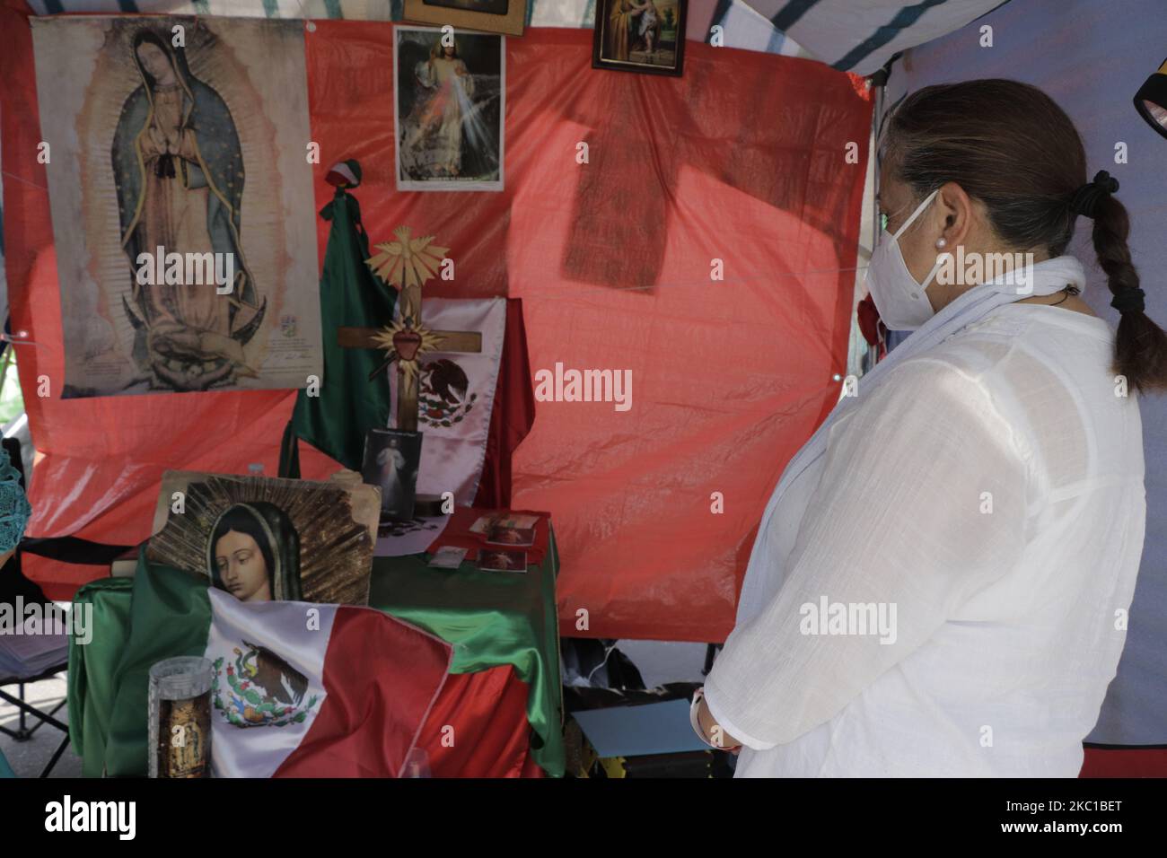 Members of the National Anti-AMLO Front (FRENAAA), set up an altar in a ...