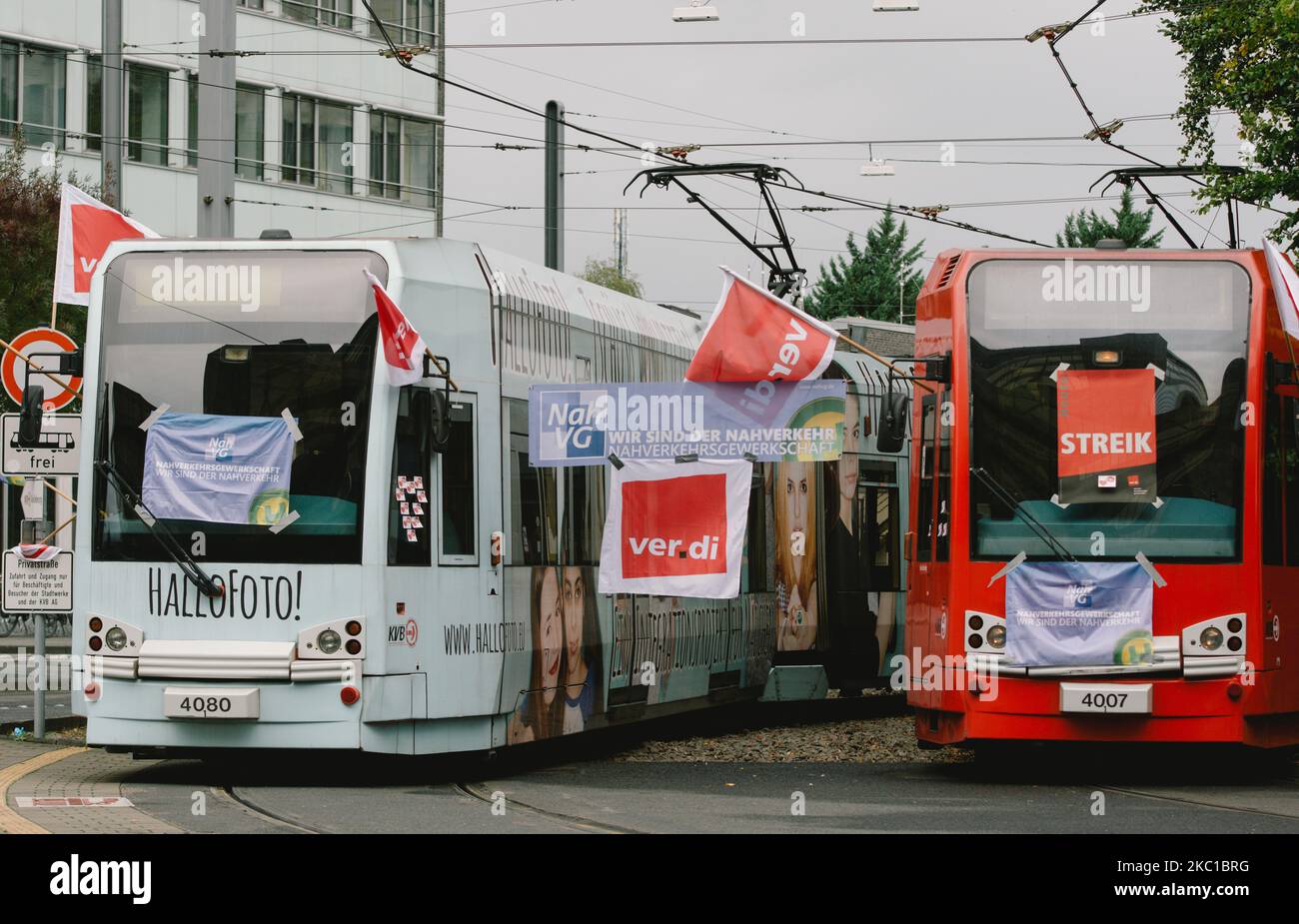 the trams are seen with striker signs and verdi union flag next to the ...